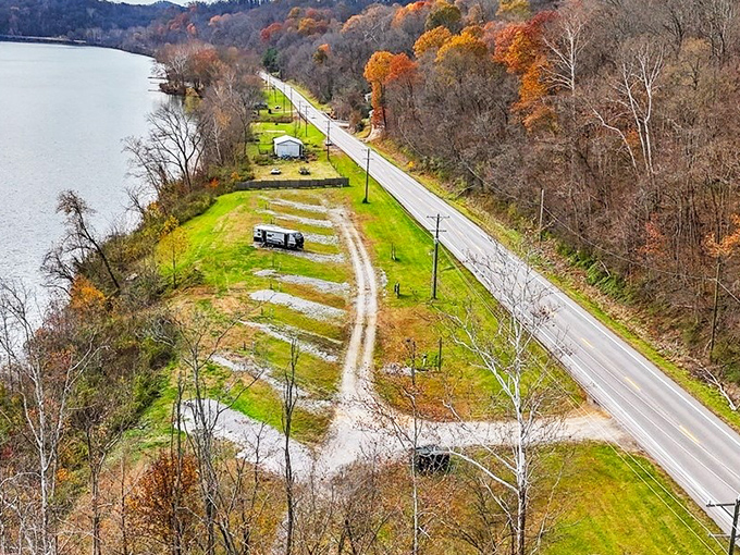From above, the river curves like nature's calligraphy, writing stories across the landscape while riverside homes watch the narrative unfold daily. 