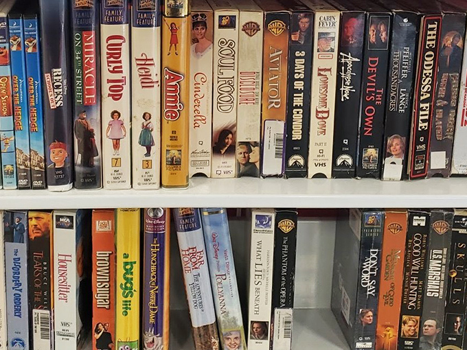 VHS tapes line the shelves like time capsules from another era. "Miracle on 34th Street" next to "Soul Food"&mdash;nostalgia by the inch.