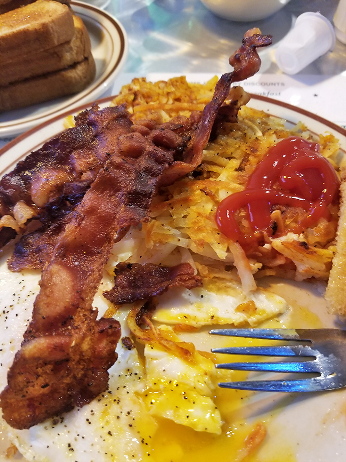 Crispy hash browns, perfectly cooked eggs, and bacon that could make a vegetarian question their life choices&mdash;breakfast doesn't get more honest than this.