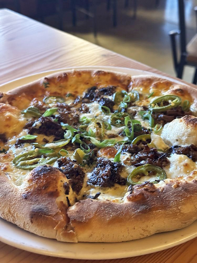 Behold the star attraction: smoked brisket pizza that makes other pizzas seem like they're not even trying. Those green onions are the perfect finishing touch!