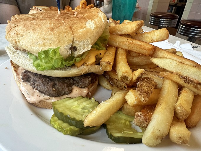 This isn't just a burger—it's an architectural masterpiece of beef, cheese, and fresh toppings that requires both hands and several napkins.