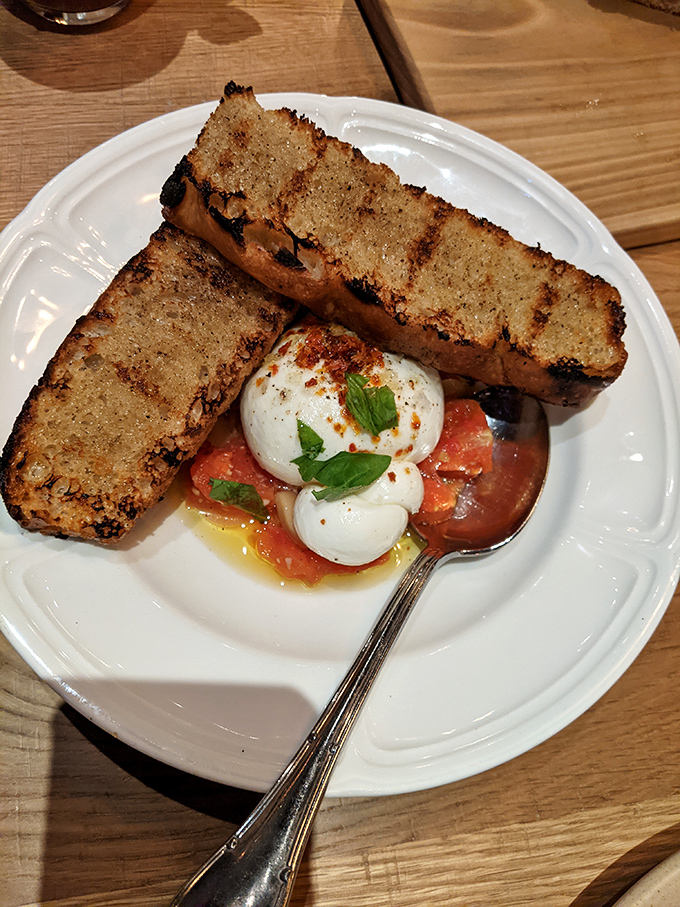 Grilled bread meets burrata in a summer romance that's meant to last. The fresh herbs and tomatoes are just playing matchmaker.