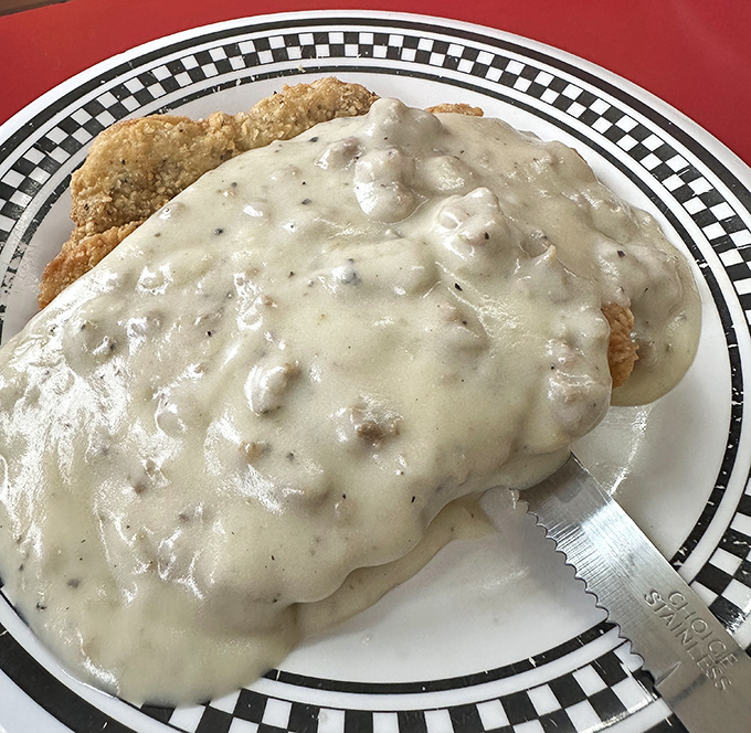 
Behold the chicken fried steak&mdash;a crispy, golden masterpiece swimming in creamy gravy that would make your cardiologist wince and your taste buds sing hallelujah. 