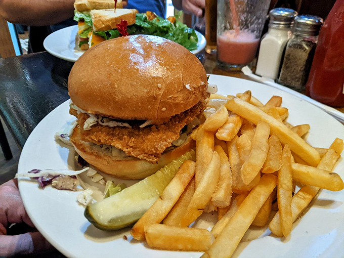 This isn't just a sandwich—it's an architectural masterpiece of crispy coating, fresh toppings, and a bun that somehow defies the laws of physics.