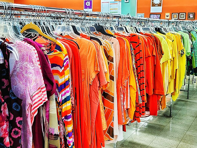 The clothing rainbow effect: organized by color, these racks transform shopping from chaotic scavenger hunt to delightful browsing experience.
