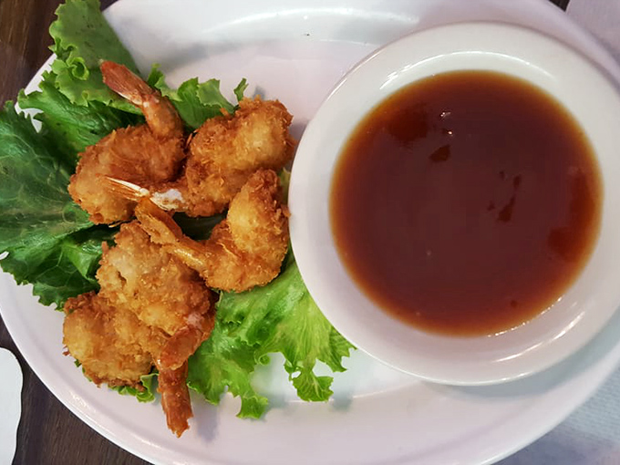 Golden coconut shrimp that crunch like a satisfying high-five to your taste buds, served with a dipping sauce worth bottling.