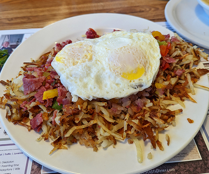 Behold the corned beef hash &ndash; a mountain of crispy potatoes and savory meat crowned with a perfect sunny-side up egg. Breakfast royalty!