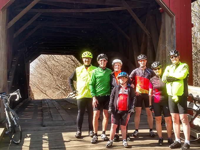 A group of cyclists makes the bridge their milestone moment, proving some landmarks are best experienced through human-powered transportation.