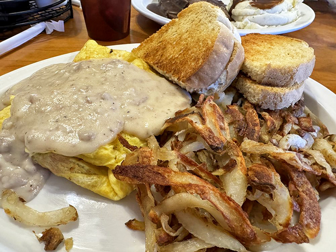 This plate of biscuits and gravy with country fries looks like what heaven serves for brunch on Sundays.