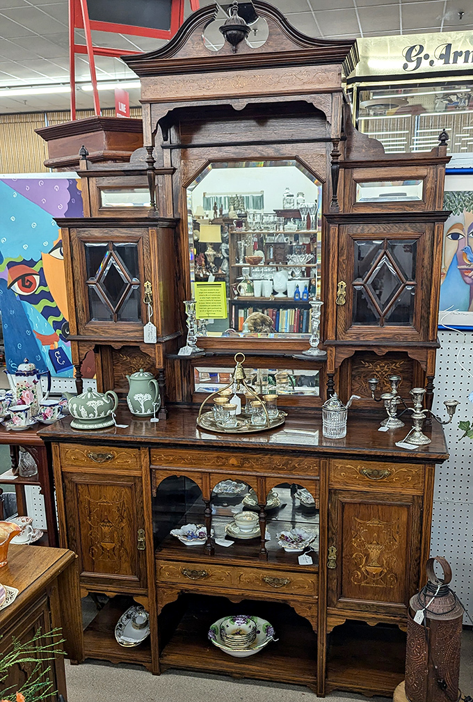 Victorian craftsmanship meets modern treasure hunting. This ornate hutch has probably witnessed more family dinners than Thanksgiving at Grandma's house.