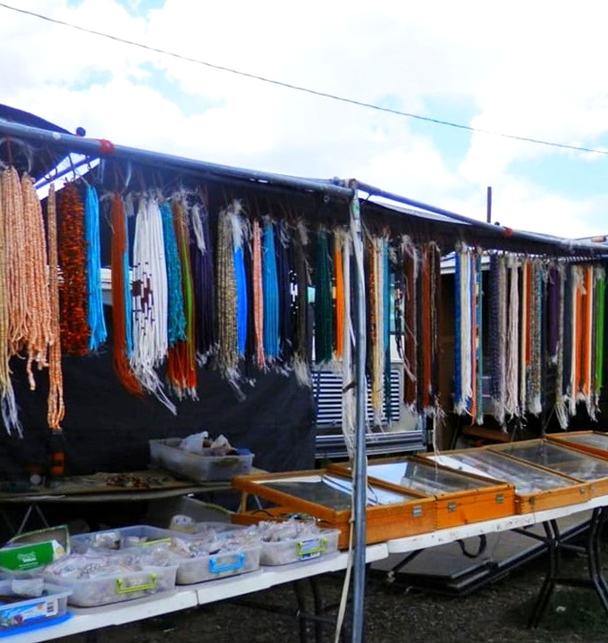 Strands of handcrafted beads create a hypnotic tapestry of color. Each necklace represents hours of meticulous work and generations of tradition.