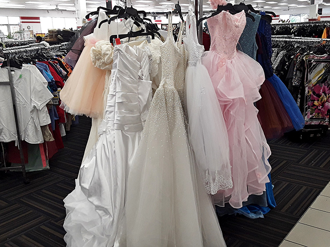 Wedding and formal dresses hang like elegant ghosts of celebrations past, ready for new memories at a fraction of retail prices.