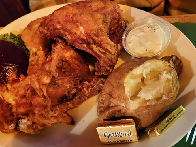 Broasted chicken that shatters with crackling perfection, paired with a loaded baked potato that's practically a meal itself.