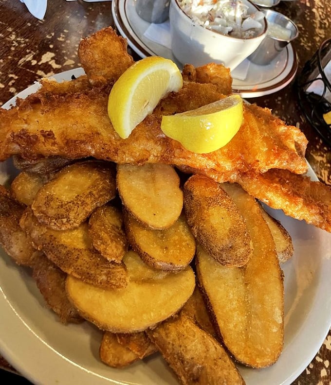 Golden-battered fish alongside thick-cut chips that would make any Irish grandmother nod approvingly while reaching for the malt vinegar.