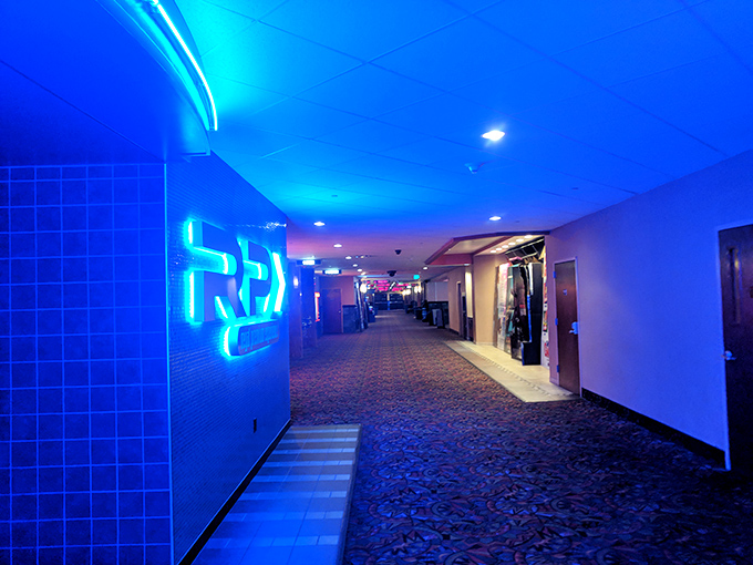 Blue-lit corridors guide bargain hunters through this retail maze like a disco-era treasure map.