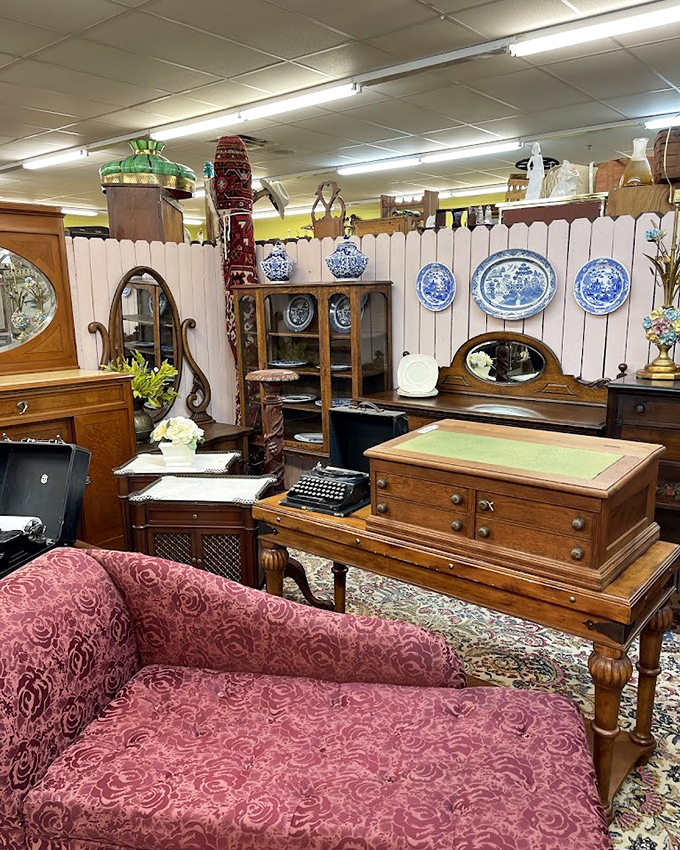A vintage typewriter sits ready for the Great American Novel, while blue and white china plates stand sentinel on a picket fence display.