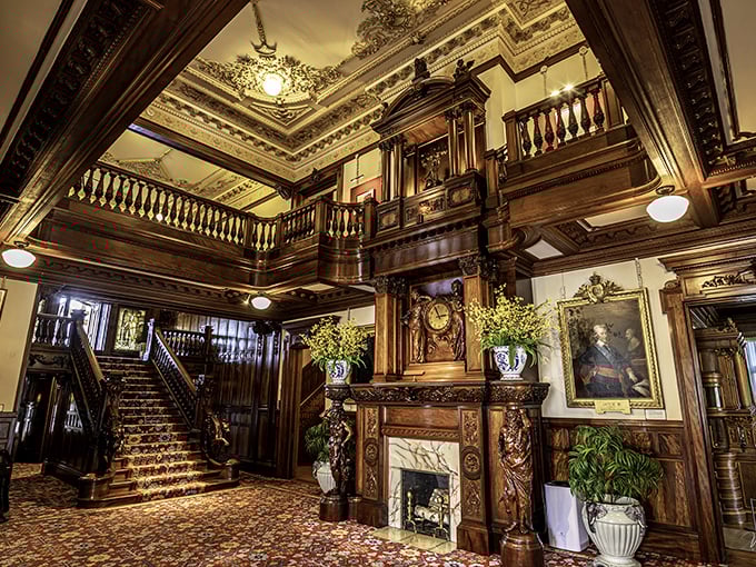 Step inside to discover a grand hall that would make Downton Abbey's designers green with envy – intricate woodwork and a staircase built for dramatic entrances.