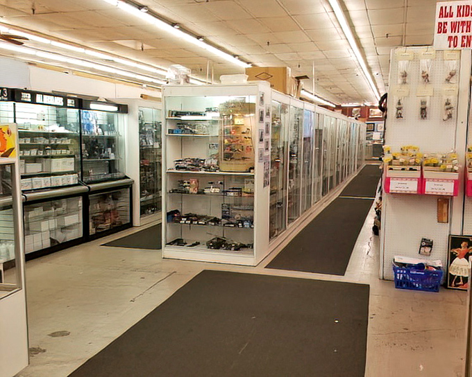 Display cases housing miniature worlds of collectibles. The serious collectors speak in hushed tones here, recognizing treasures the uninitiated might overlook.