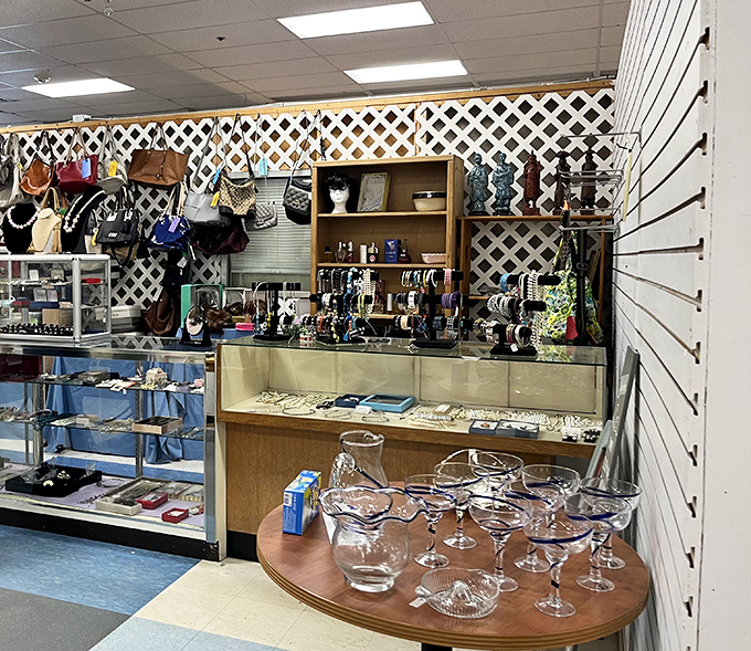 The jewelry counter: where costume pieces mingle with potential hidden gems. That lattice wall display of handbags is a thrifter's dream come true.