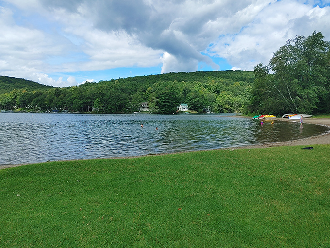 Lake views that make smartphone wallpapers jealous. The gentle slope of manicured grass meets crystal waters under Vermont's impossibly blue skies.