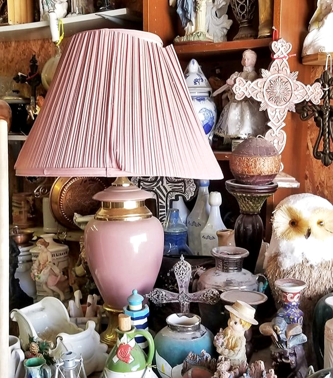 Pink ceramic lamps sharing shelf space with vintage treasures, because eclectic never goes out of style.