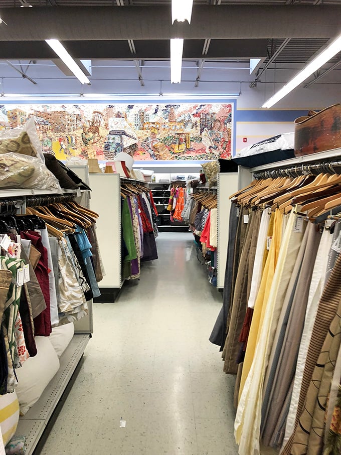 Fashion canyon! Rows upon rows of carefully organized clothing create a textile rainbow where vintage treasures hide among everyday essentials.