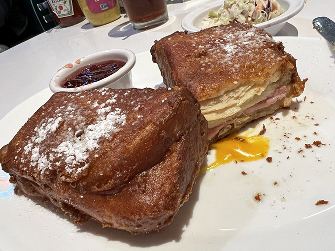 The legendary Monte Cristo in all its golden-fried glory. That dusting of powdered sugar isn't just decoration&mdash;it's essential magic.
