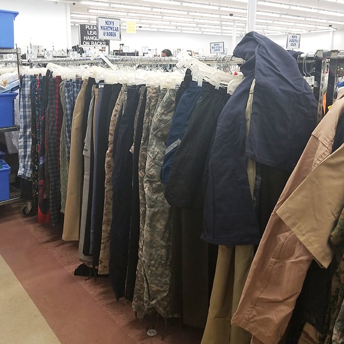 Military fatigues hang alongside dress pants in perfect harmony. In the democracy of thrift, a general's uniform costs the same as a banker's slacks.
