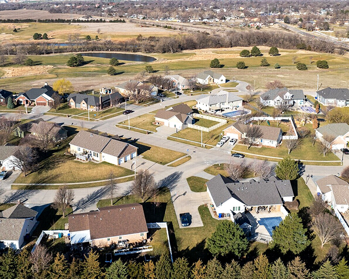 Suburban serenity defines McPherson's residential neighborhoods, where well-maintained homes surround community ponds&mdash;no oceanfront prices required.