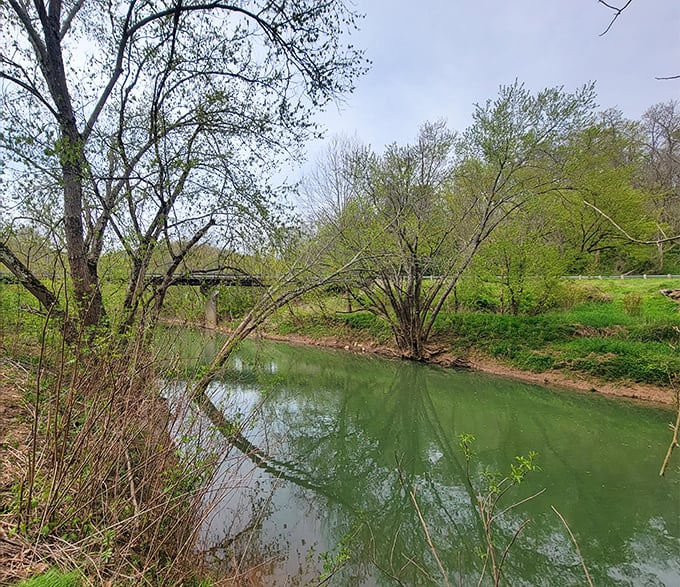 The creek below offers a serene soundtrack to your visit—nature's own meditation app, but without the monthly subscription fee.