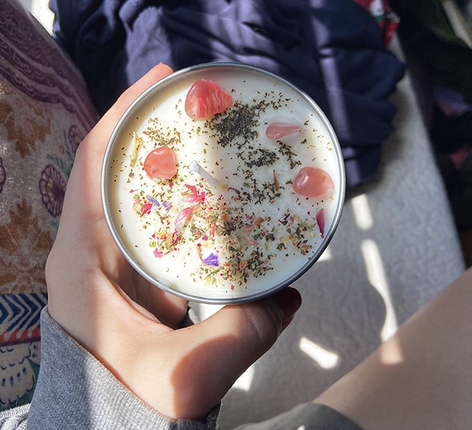 Artisanal candle craftsmanship at its finest—flower petals suspended in wax like a botanical time capsule, releasing Vermont meadows with each gentle flicker.