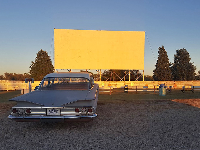 A vintage Chevy finds the perfect parking spot at sunset, when the drive-in transforms from simple screen to memory-making machine.