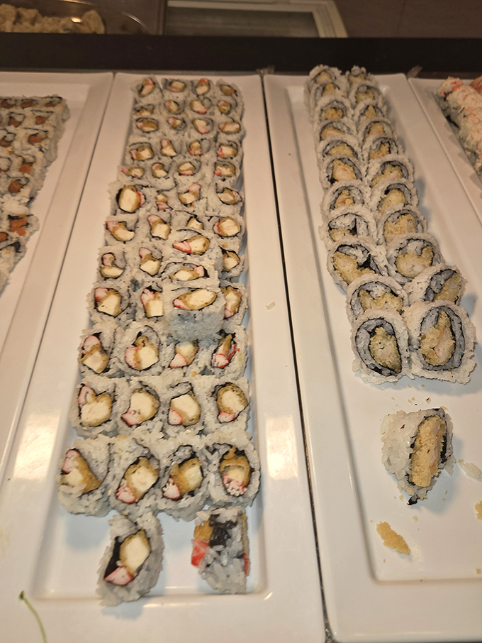 Sushi rolls lined up like edible dominos, each one a perfect bite-sized promise that buffet sushi doesn't have to be a gamble.
