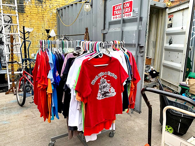 Vintage tees hanging like colorful flags of nostalgia. That red "Trouble Club" shirt has definitely seen some stories worth telling.
