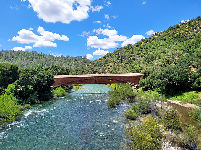 Nature frames this architectural marvel perfectly. The South Yuba River's gentle flow beneath the bridge creates a scene worthy of a thousand screensavers.