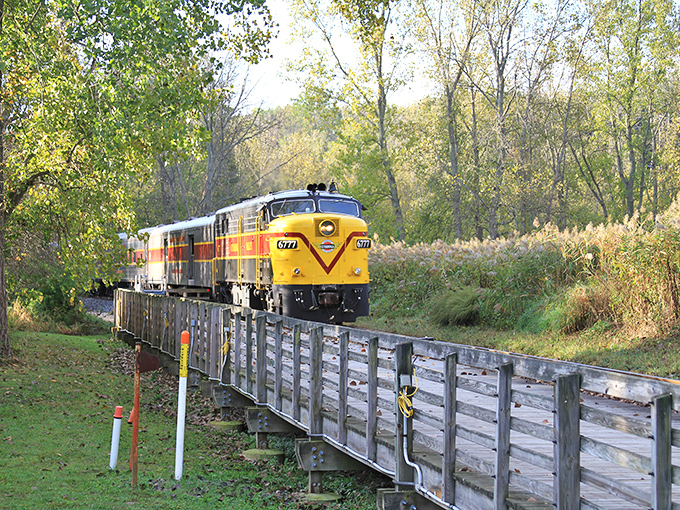 Fall's fiery palette transforms the valley into nature's art gallery. The train tracks cutting through remind us humans occasionally get something right.