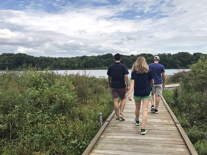 The wooden boardwalk through Punderson's wetlands &ndash; where conversations pause naturally as the scenery demands your full attention.