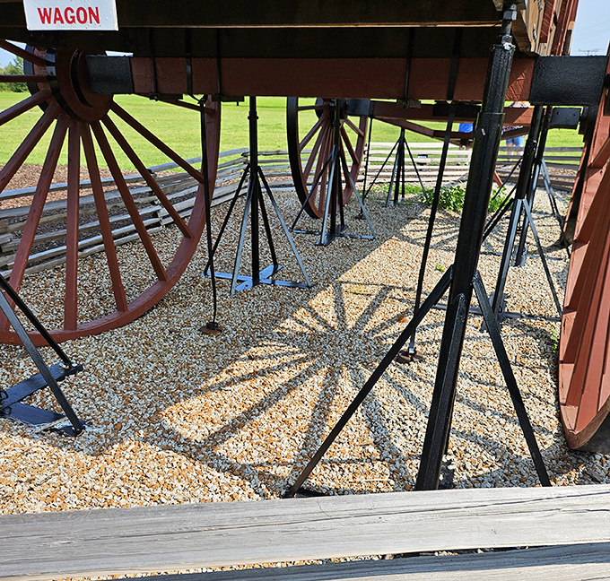 Engineering marvel meets historical tribute. The massive wooden wheels create mesmerizing shadows on the gravel below&mdash;structural support has never looked so photogenic.