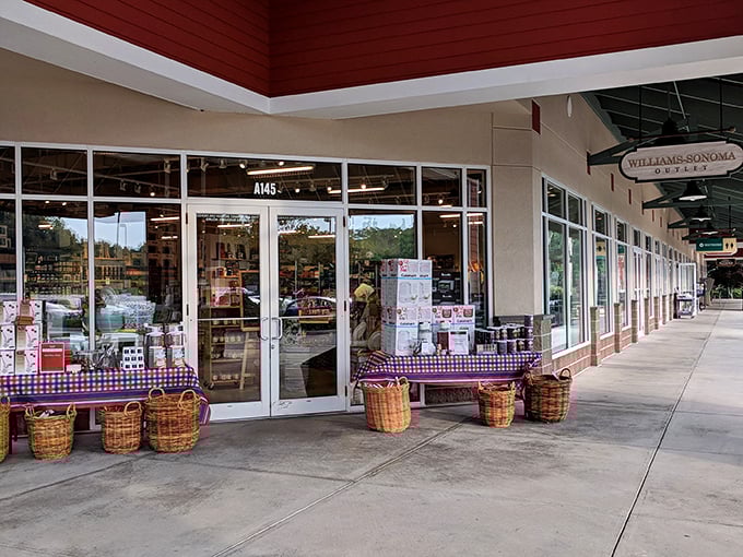 Williams-Sonoma Outlet tempts passersby with culinary treasures displayed outside. Kitchen gadgets: where impulse buys and good intentions meet.