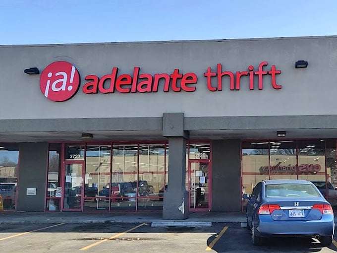 &iexcl;Adelante! The thrift store's punchy red signage pops against concrete gray&mdash;Kansas City's multicultural treasure chest awaits under clear blue skies.