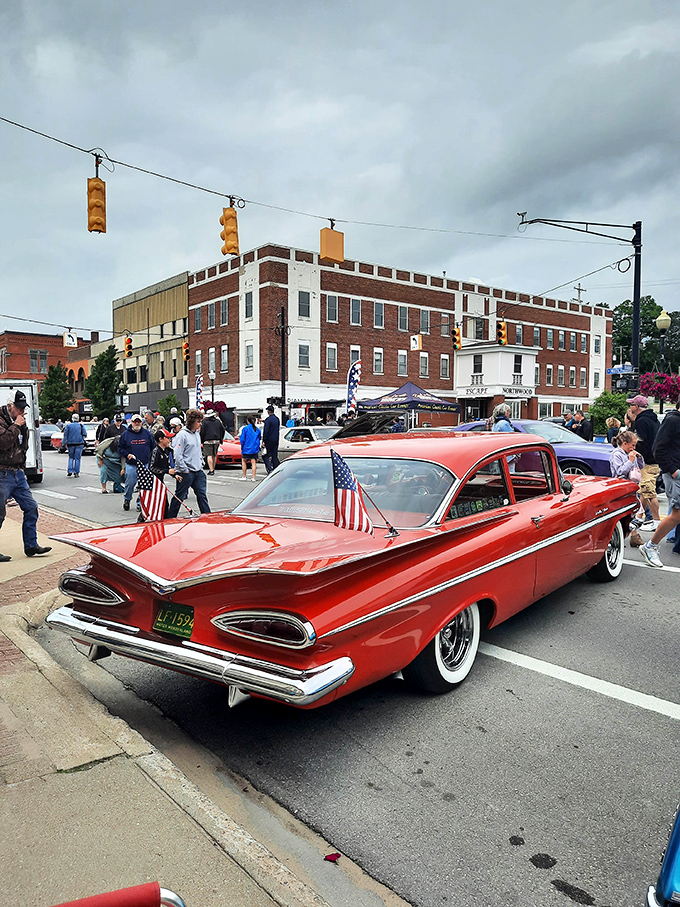 That cherry-red Chevy with tiny American flags steals the show at Cadillac's car festival &ndash; Detroit's golden era parked right on Main Street.