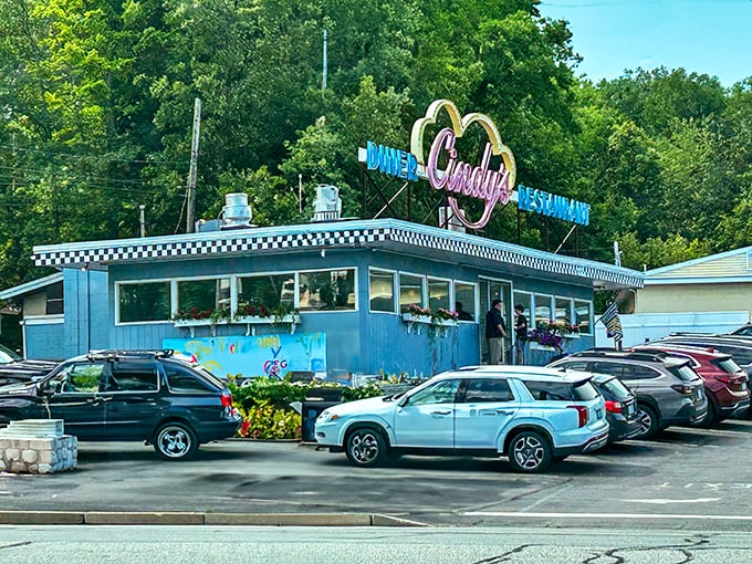 Cindy's vibrant blue exterior pops against summer greenery. This cheerful diner promises pancakes that would make your grandmother proud.