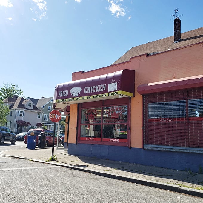 Crown Fried Chicken's vibrant orange facade is like a beacon for hungry souls seeking crispy salvation.