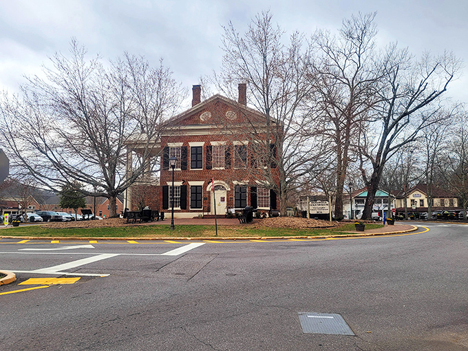 Dahlonega's historic brick courthouse stands proudly among winter-bare trees, like a dignified elder waiting for spring's return.