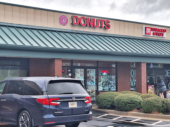 Strip mall exteriors can be deceiving - behind that modest brick facade lies some seriously impressive donut craftsmanship.