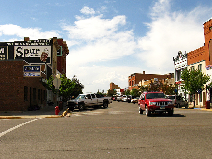 Downtown Evanston welcomes visitors with classic brick buildings, friendly shops, and small-town charm beneath the bright Wyoming sky.
