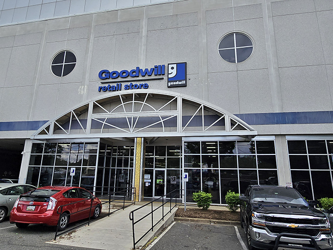 Goodwill's sleek facade belies the chaos of possibilities within. Those round windows are portholes to a sea of secondhand treasures.