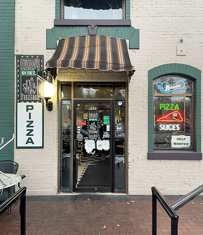 Guido's striped awning and vintage storefront scream "authentic New York slice" louder than a Yankee fan at a Red Sox game.