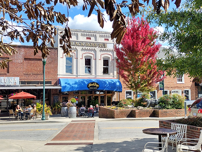 The Black Rose Pub's outdoor seating beckons with the promise of cold drinks and warm conversation in downtown Hendersonville.