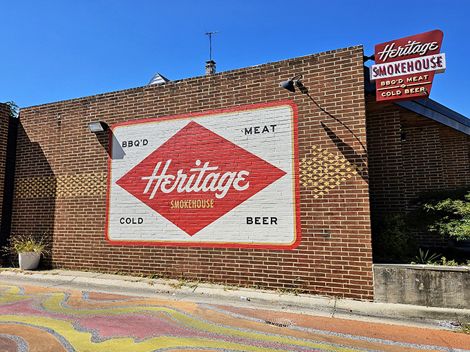 Heritage Smokehouse's vintage-style painted sign feels like a discovery from another era. This is where tradition meets brick&mdash;and magic happens inside.